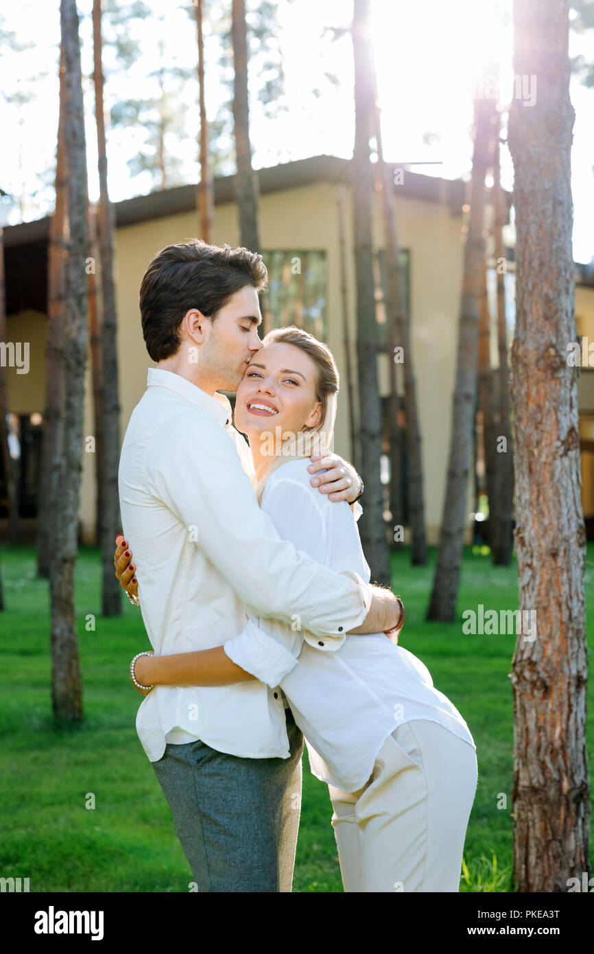 Joyful happy woman being hugged by her boyfriend Stock Photo - Alamy