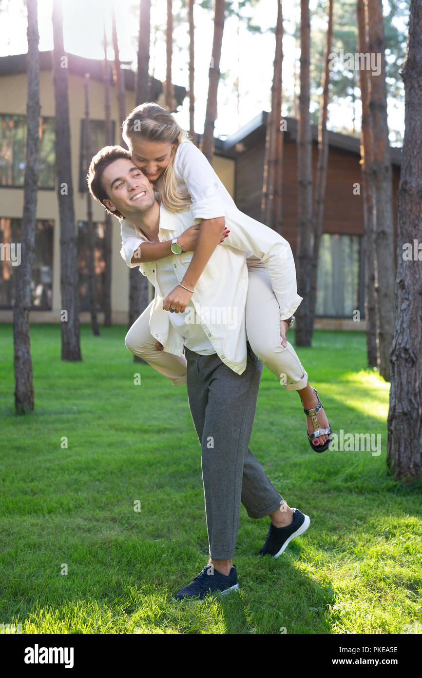 Nice handsome strong man carrying his girlfriend Stock Photo - Alamy