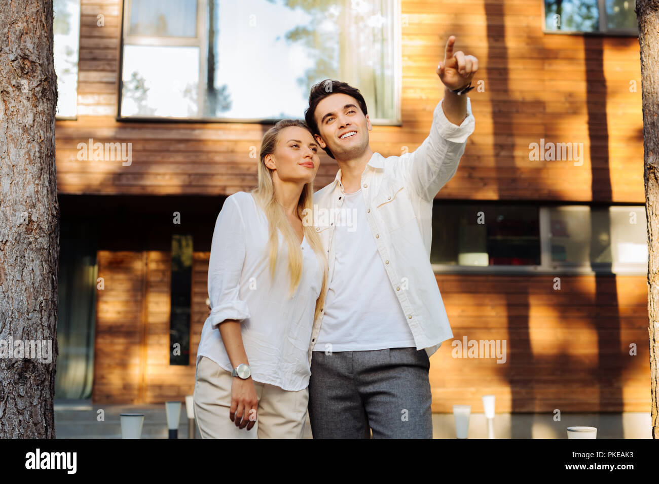 Delighted nice couple talking to each other Stock Photo - Alamy