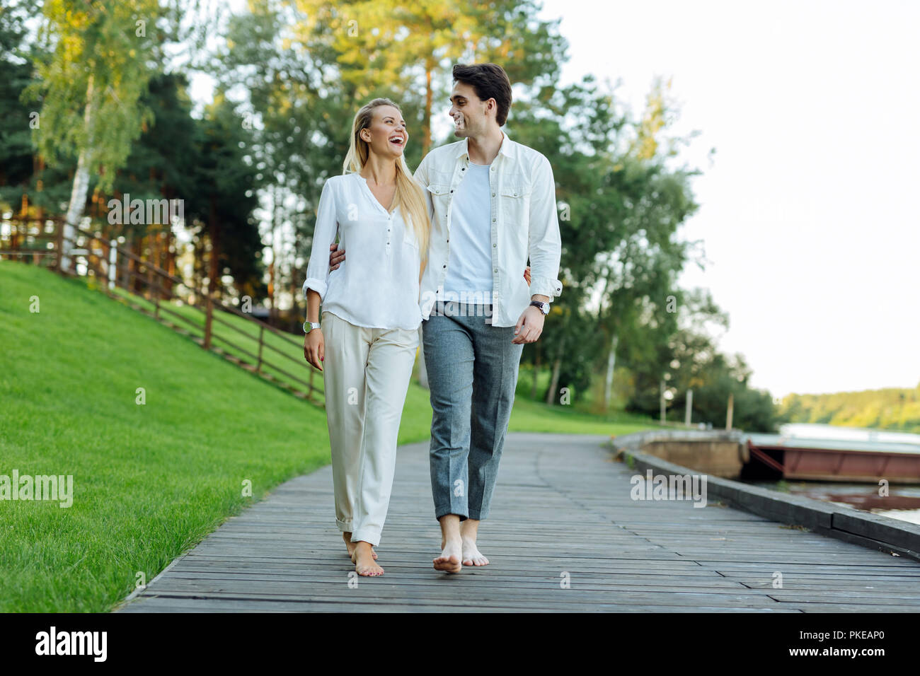 Happy nice couple laughing to each other Stock Photo - Alamy
