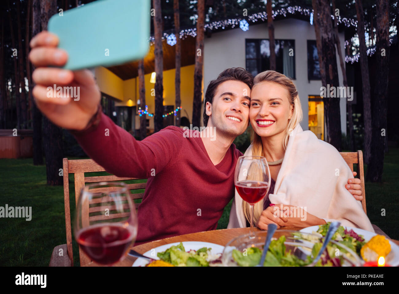 Happy nice young couple posing for a photo Stock Photo - Alamy
