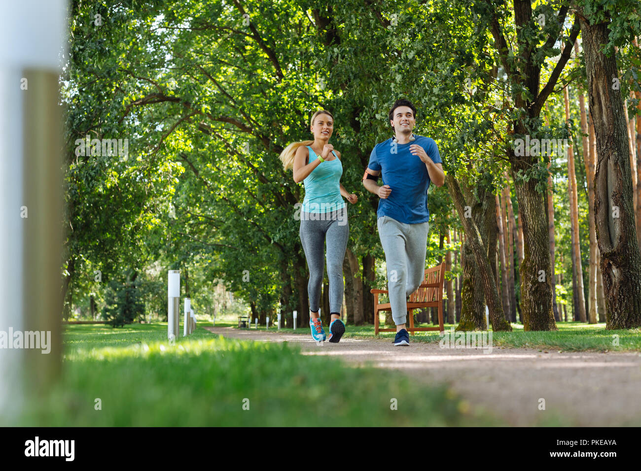 Happy positive fit couple doing cardio activities Stock Photo - Alamy