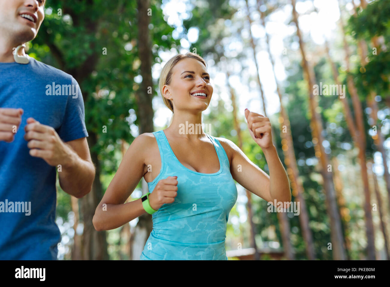 Happy positive fit people running outdoors together Stock Photo - Alamy