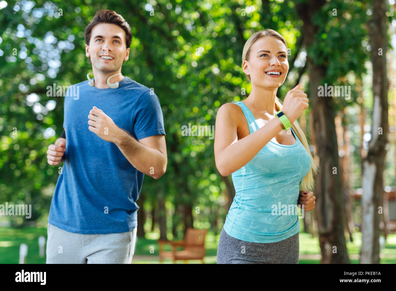 Happy nice active people enjoying running together Stock Photo - Alamy
