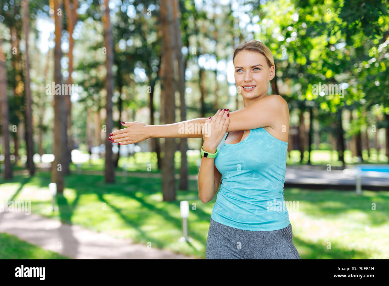 Cheerful positive young woman moving her body Stock Photo - Alamy