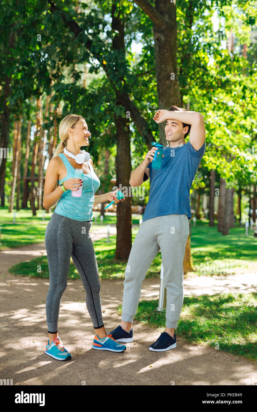 Joyful young people having a break from training Stock Photo - Alamy