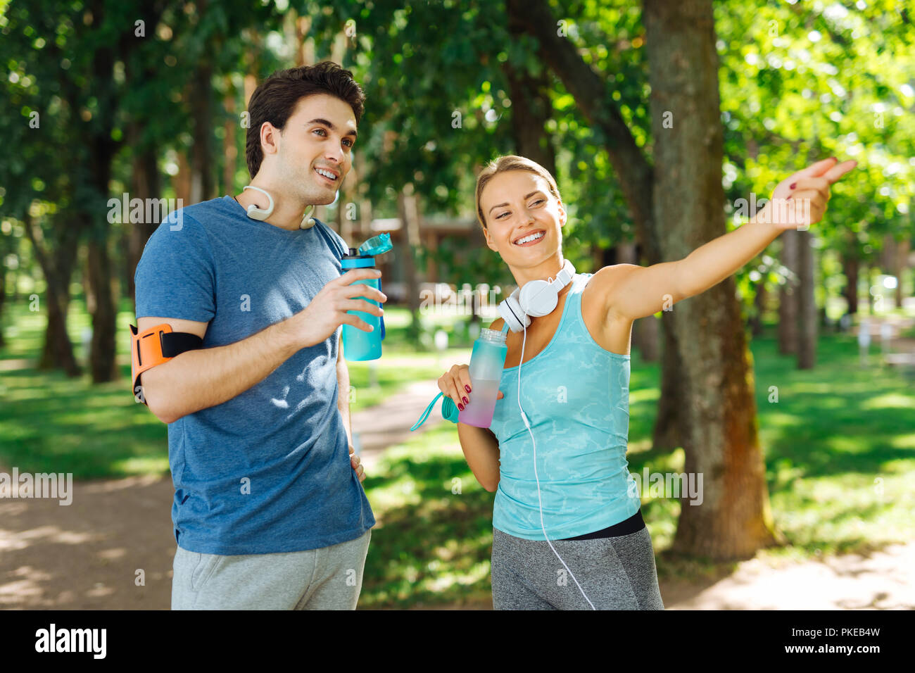 Delighted young woman holding a bottle of water Stock Photo - Alamy