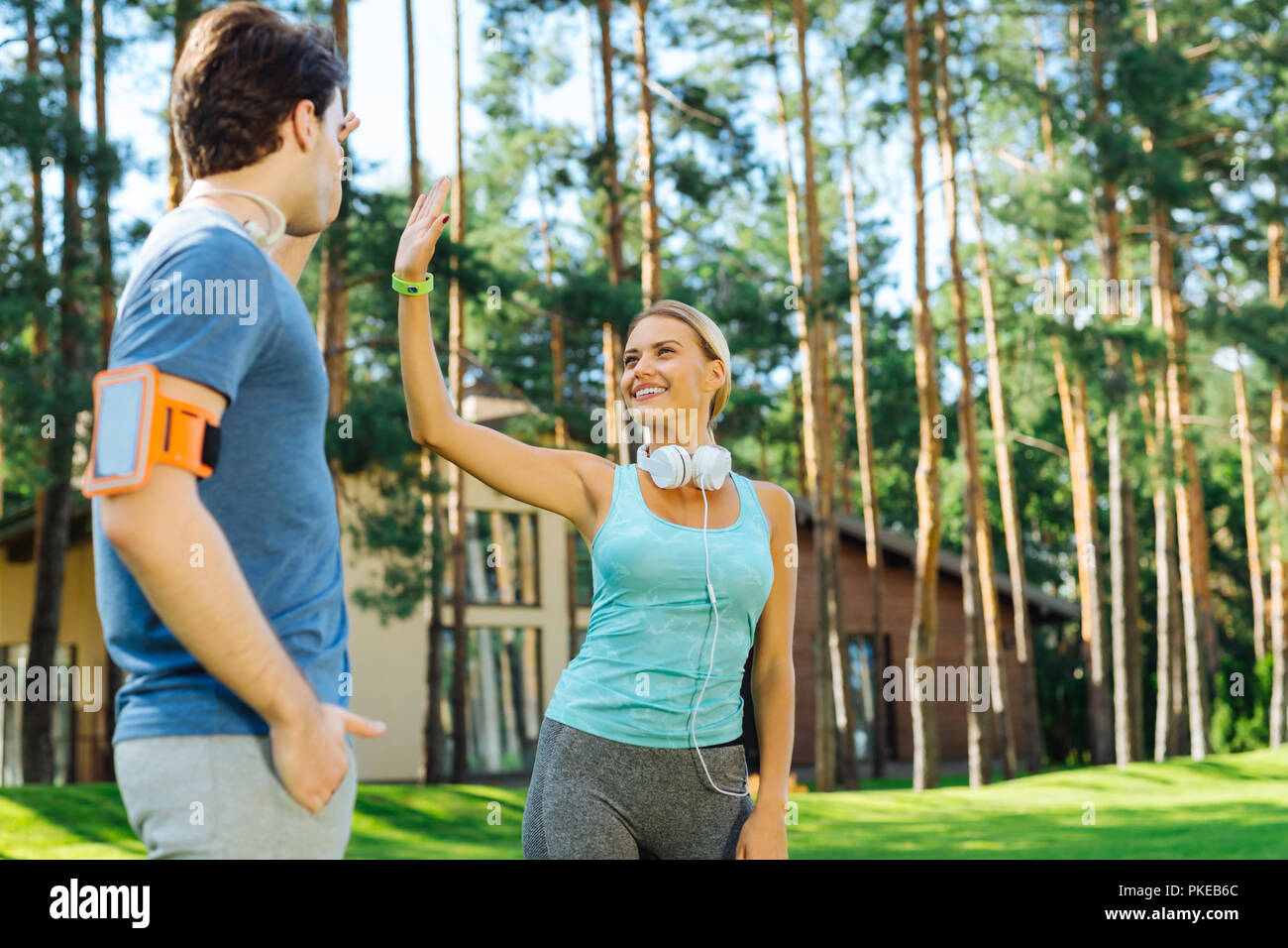 Joyful happy young woman giving a high five Stock Photo - Alamy