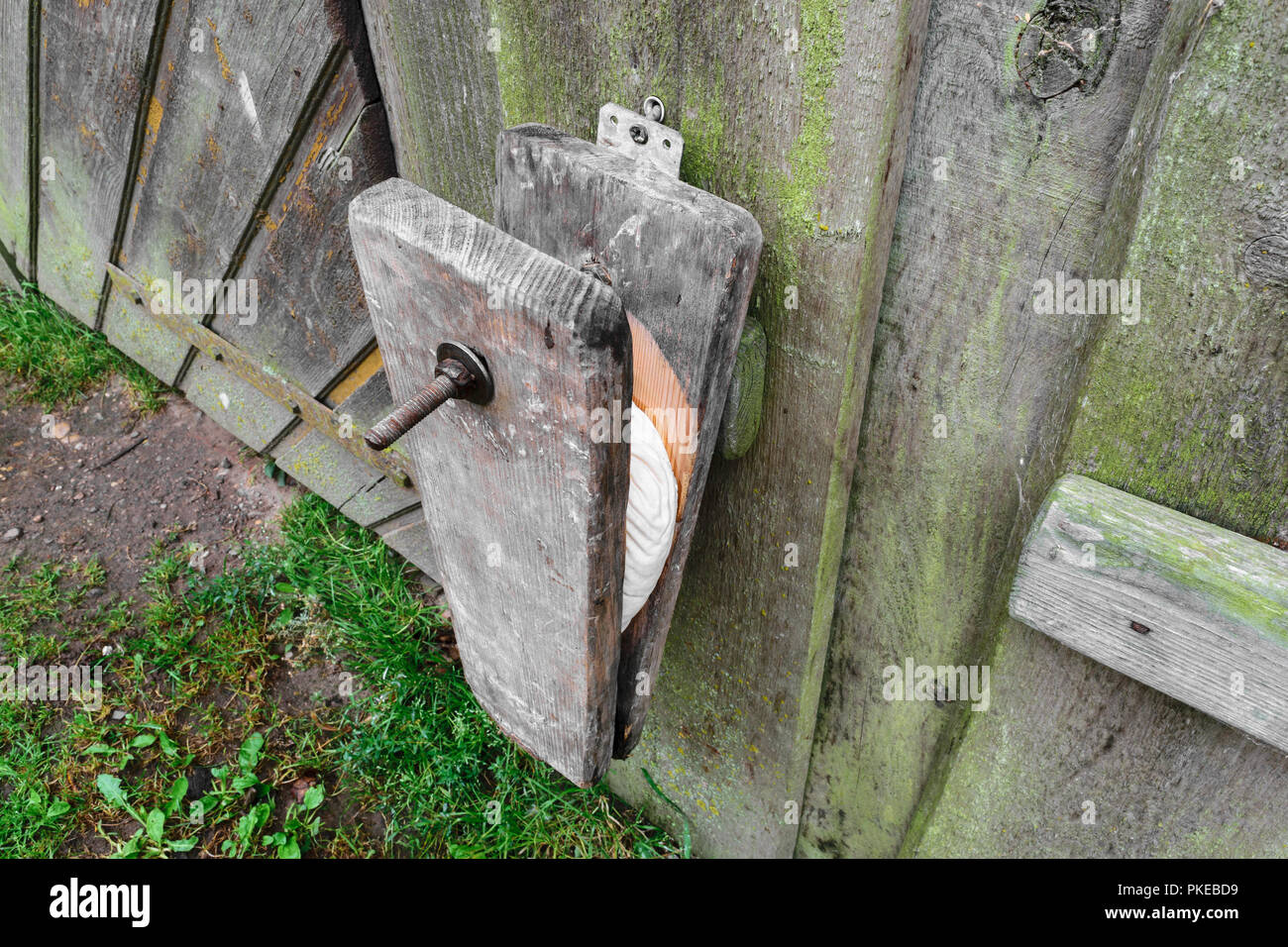 Old and traditional rural device hanging on the wall and pressing ...