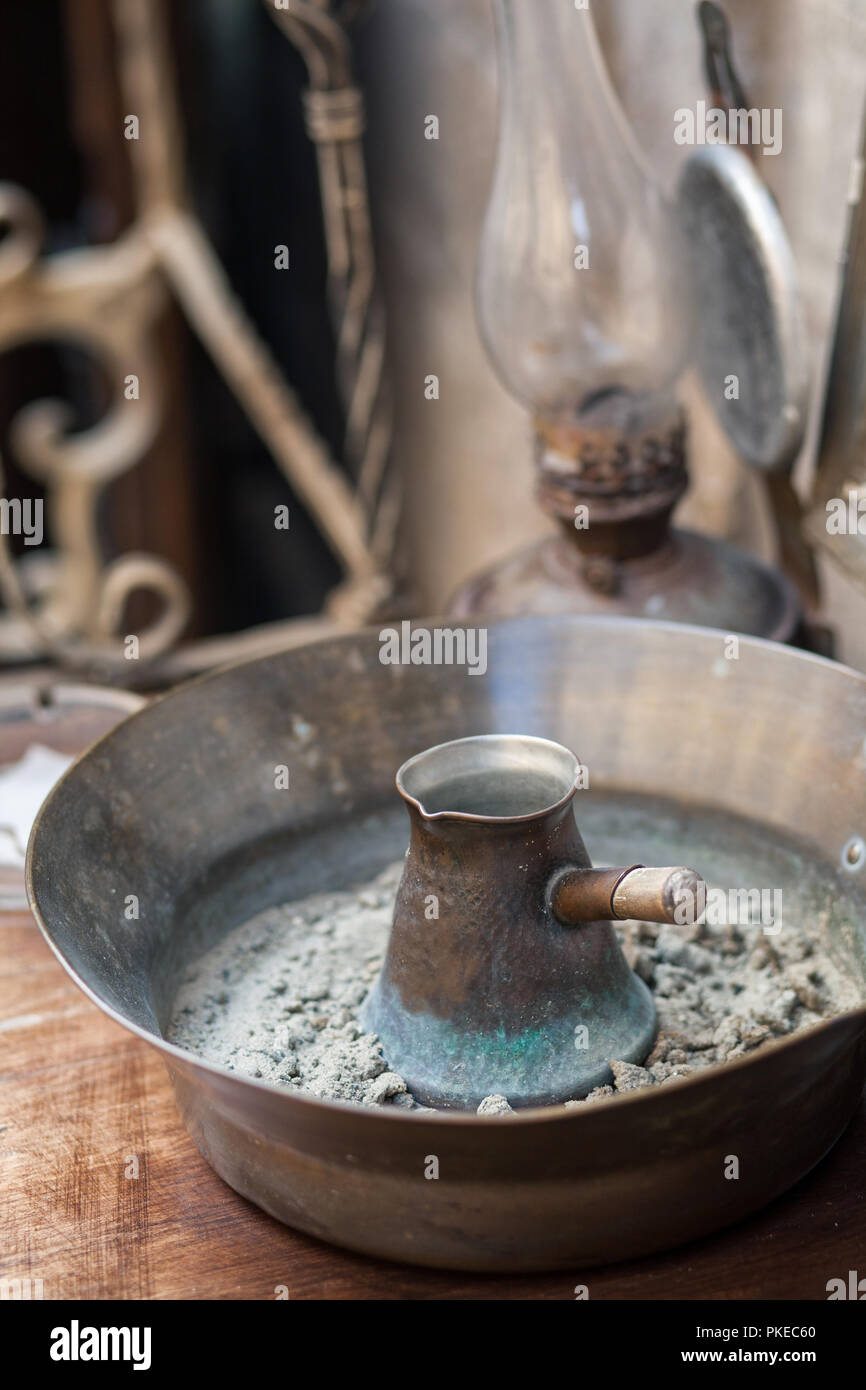 Traditional turkish coffee in cezve prepared on hot sand. Selective ...