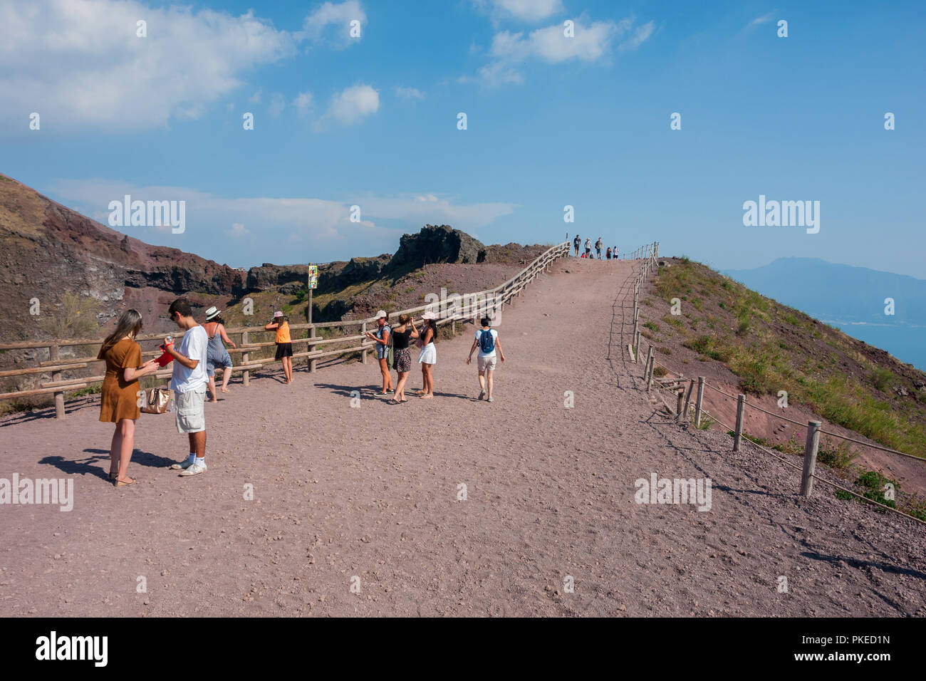 MOUNT VESUVIUS, ITALY - AUGUST 1, 2018: Tourists walk around the crater ...