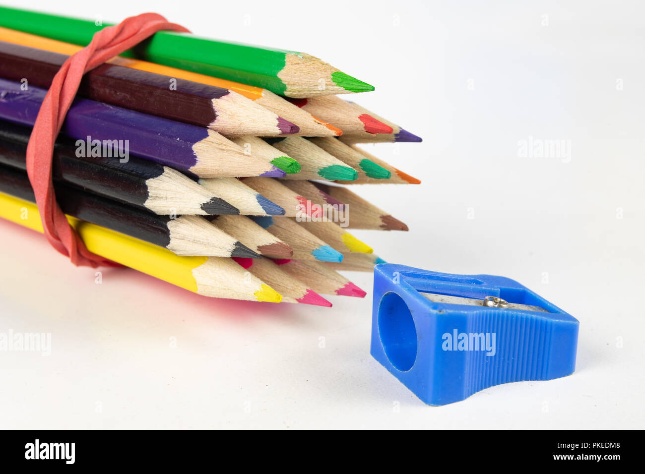 Pencil crayons on a white table. School supplies used in art lessons ...