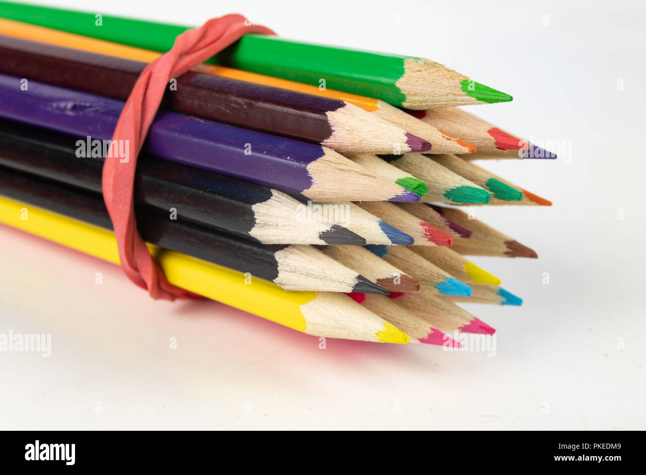 Pencil crayons on a white table. School supplies used in art lessons ...