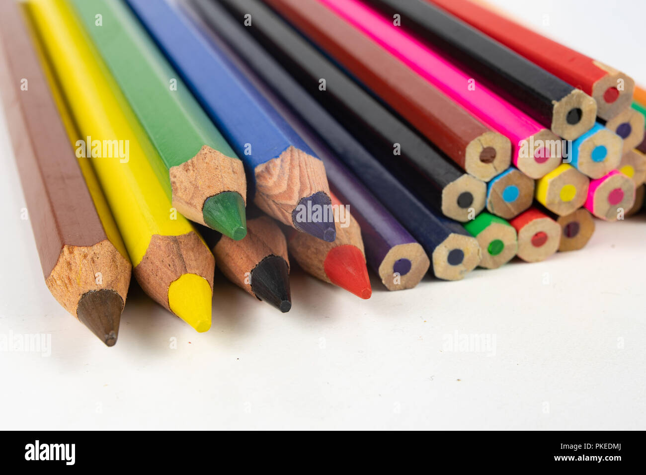 Pencil crayons on a white table. School supplies used in art lessons ...