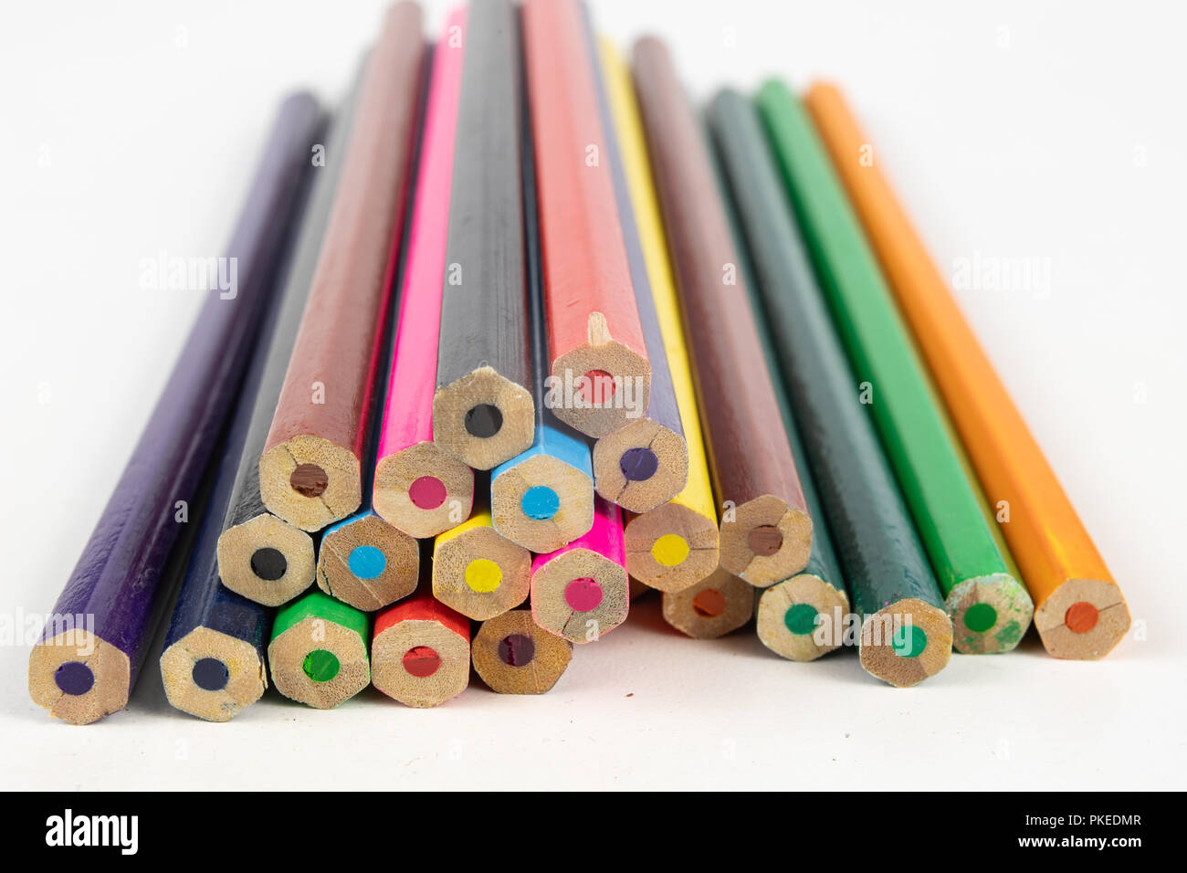 Pencil crayons on a white table. School supplies used in art lessons ...