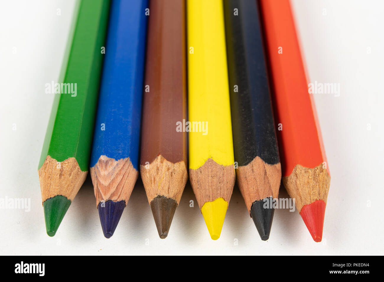Pencil crayons on a white table. School supplies used in art lessons ...