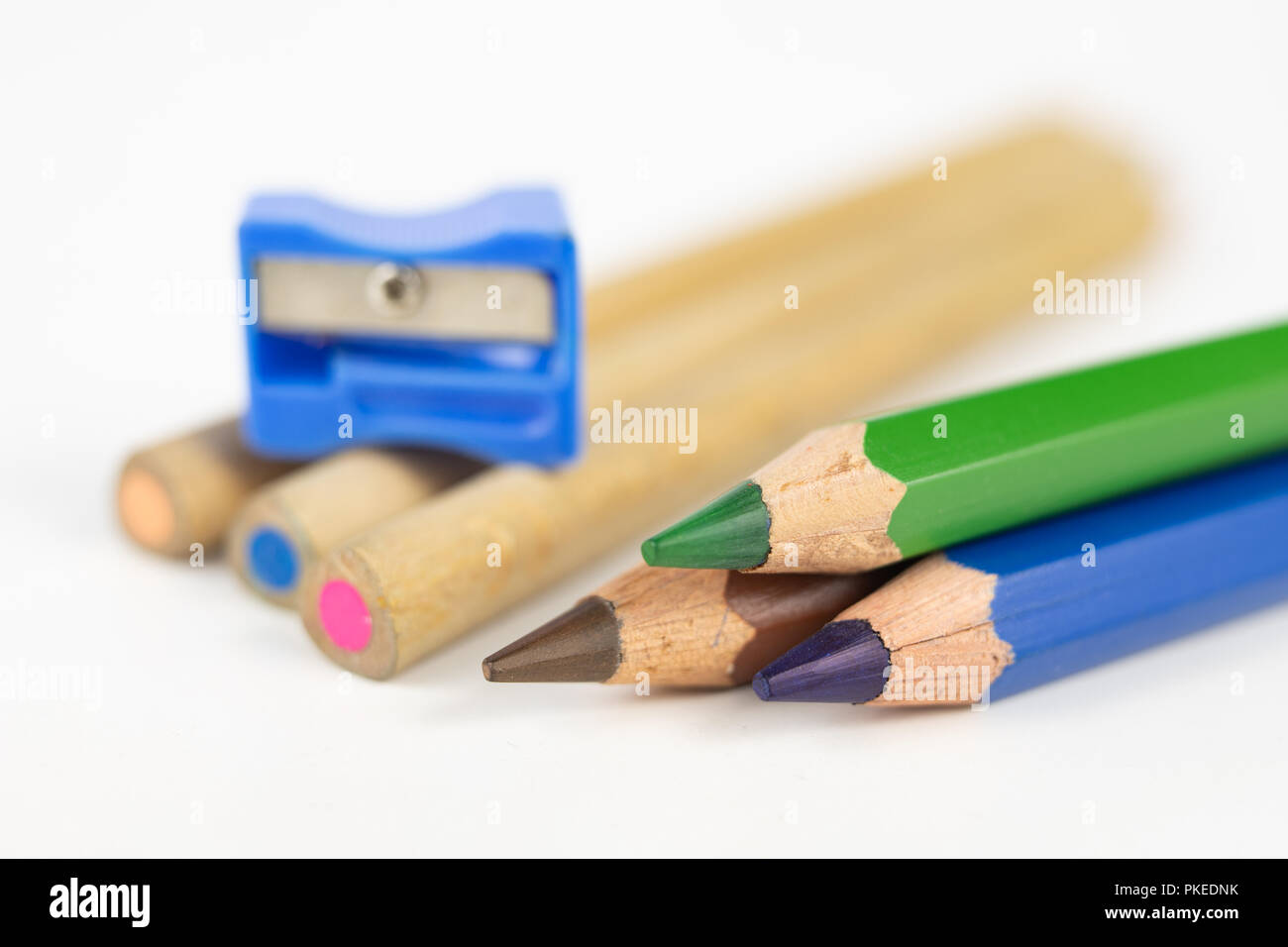 Pencil crayons on a white table. School supplies used in art lessons ...