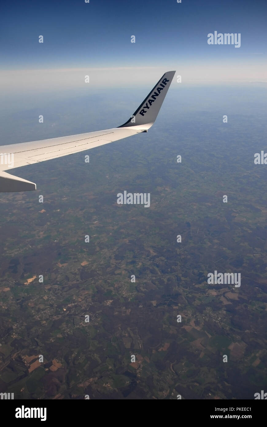 view of a Ryanair Boeing 737 - 800 wing out of plane window in flight ...