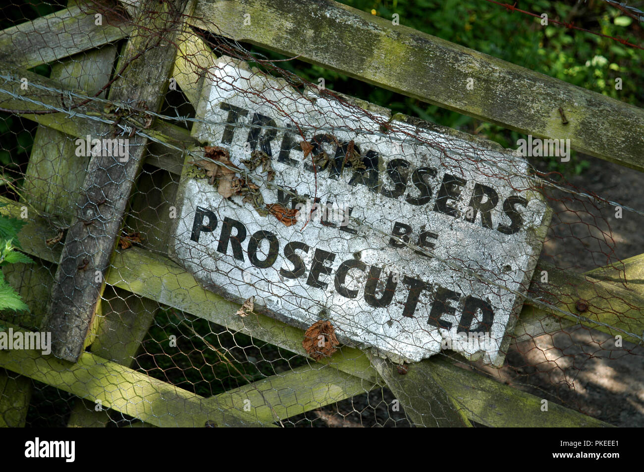 Keep Out Trespassers will be prosecuted sign on mesh metal fence Stock ...