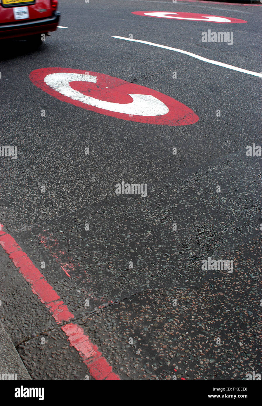 White C in red circle marked C on a road for Congestion Charge. Daily ...