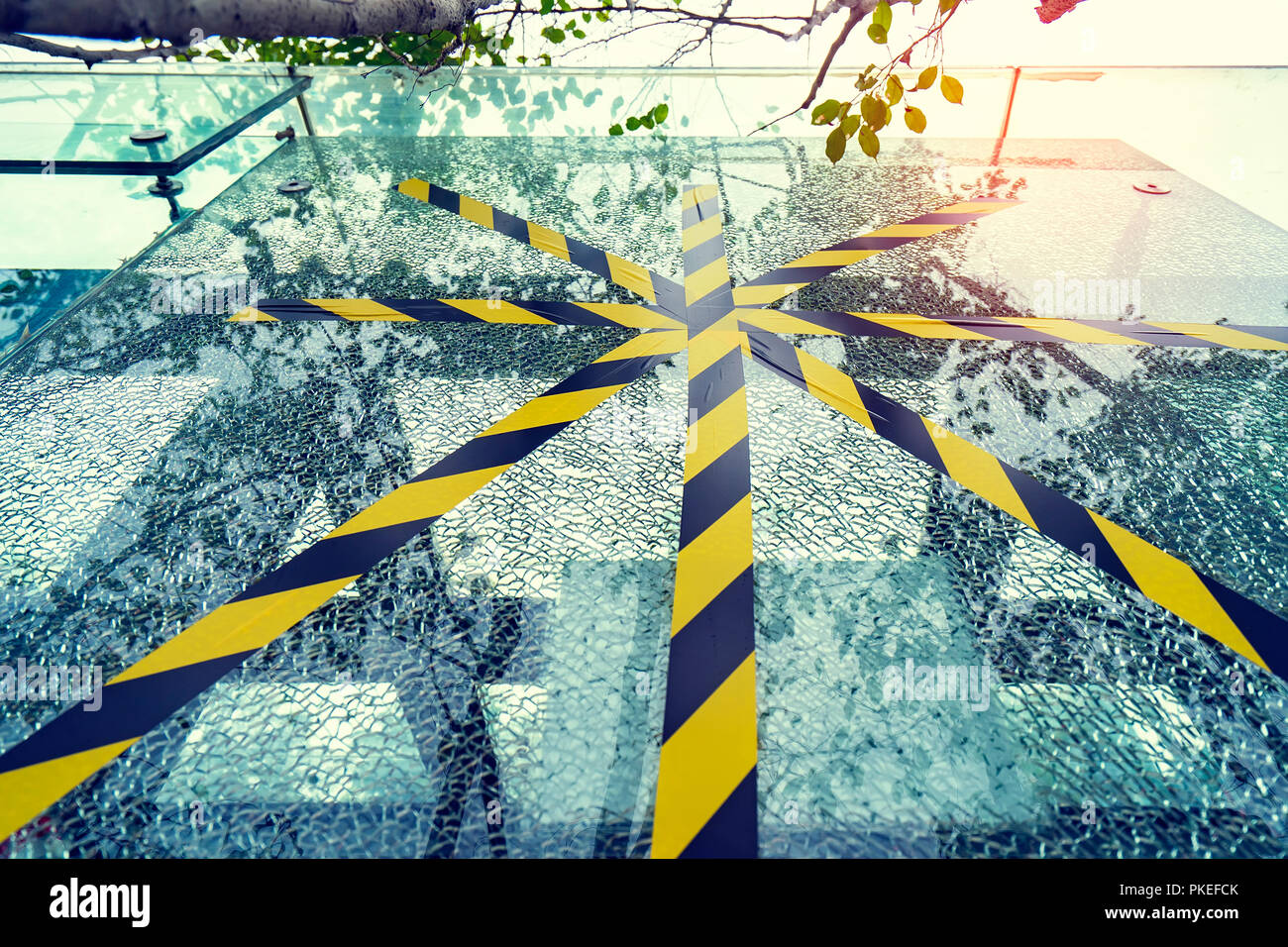 Yellow tape across broken glass window Stock Photo - Alamy