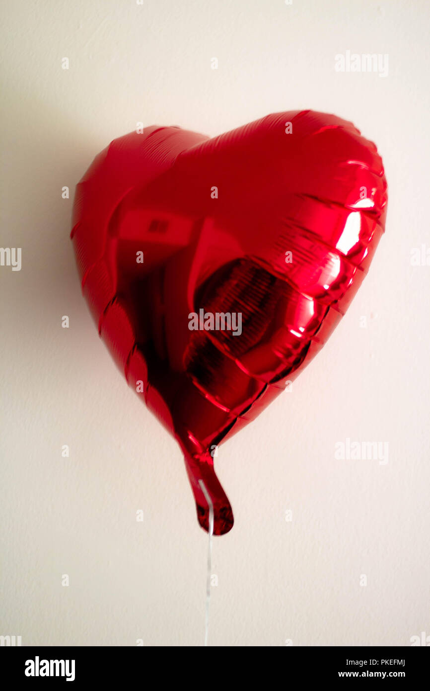 One red heart balloon with a white background Stock Photo - Alamy