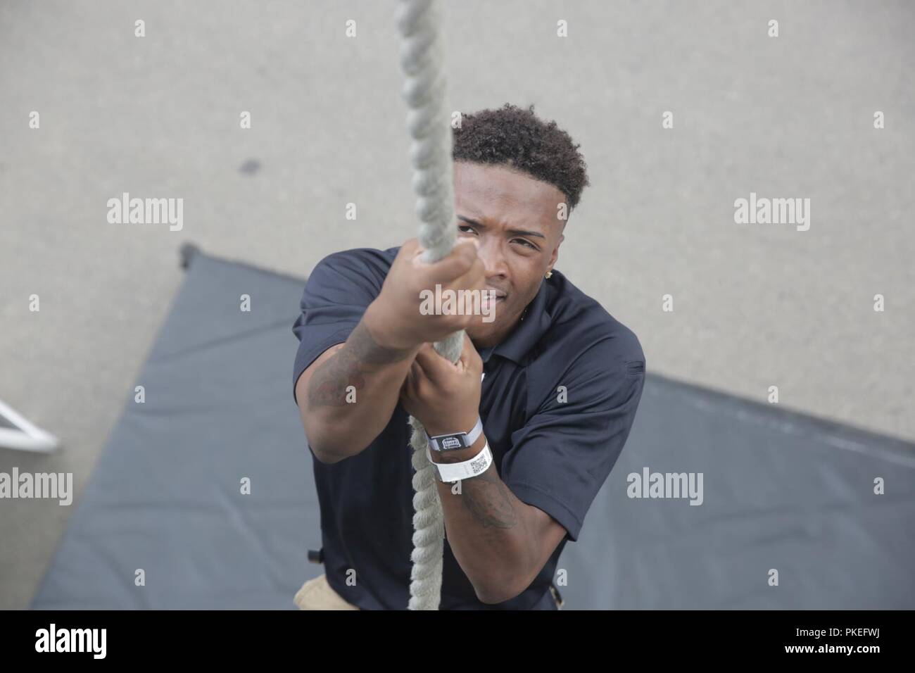 MADISON, Wisconsin – Brian Friend climbs the rope on the Marine Corps ...
