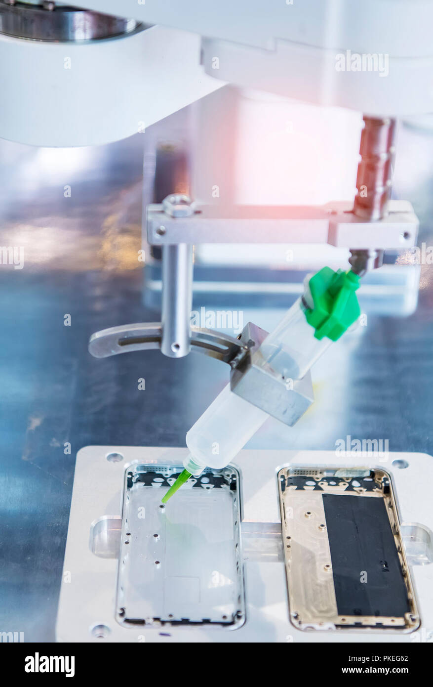 Robot holding glue syringe Injection in mobile phone factory Stock ...