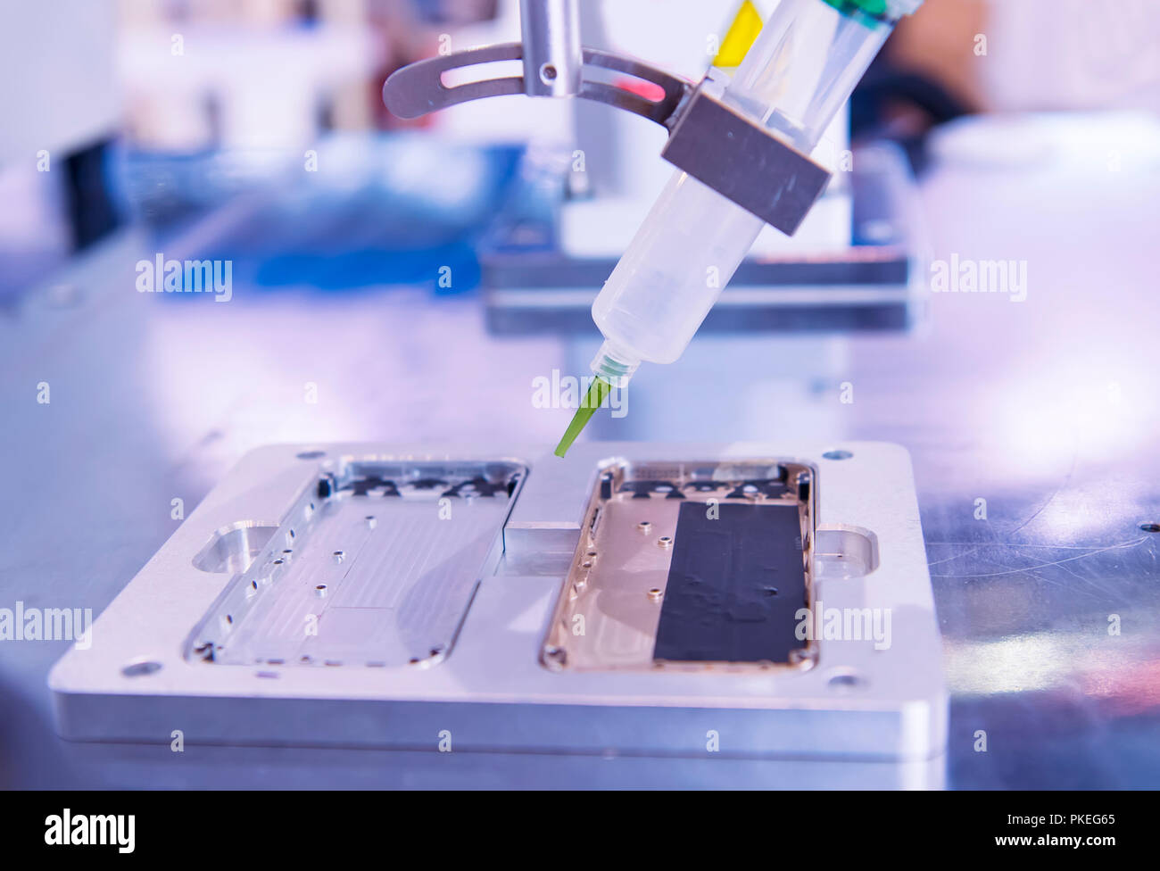 Robot holding glue syringe Injection in mobile phone factory Stock ...