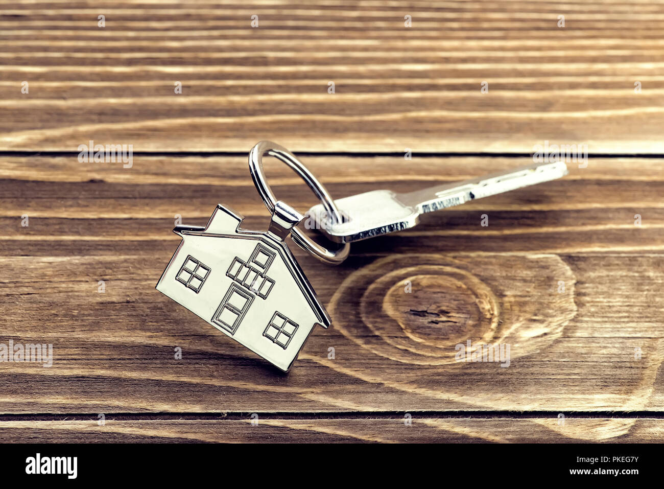 keychain with house symbol and keys on wooden background,Real estate ...