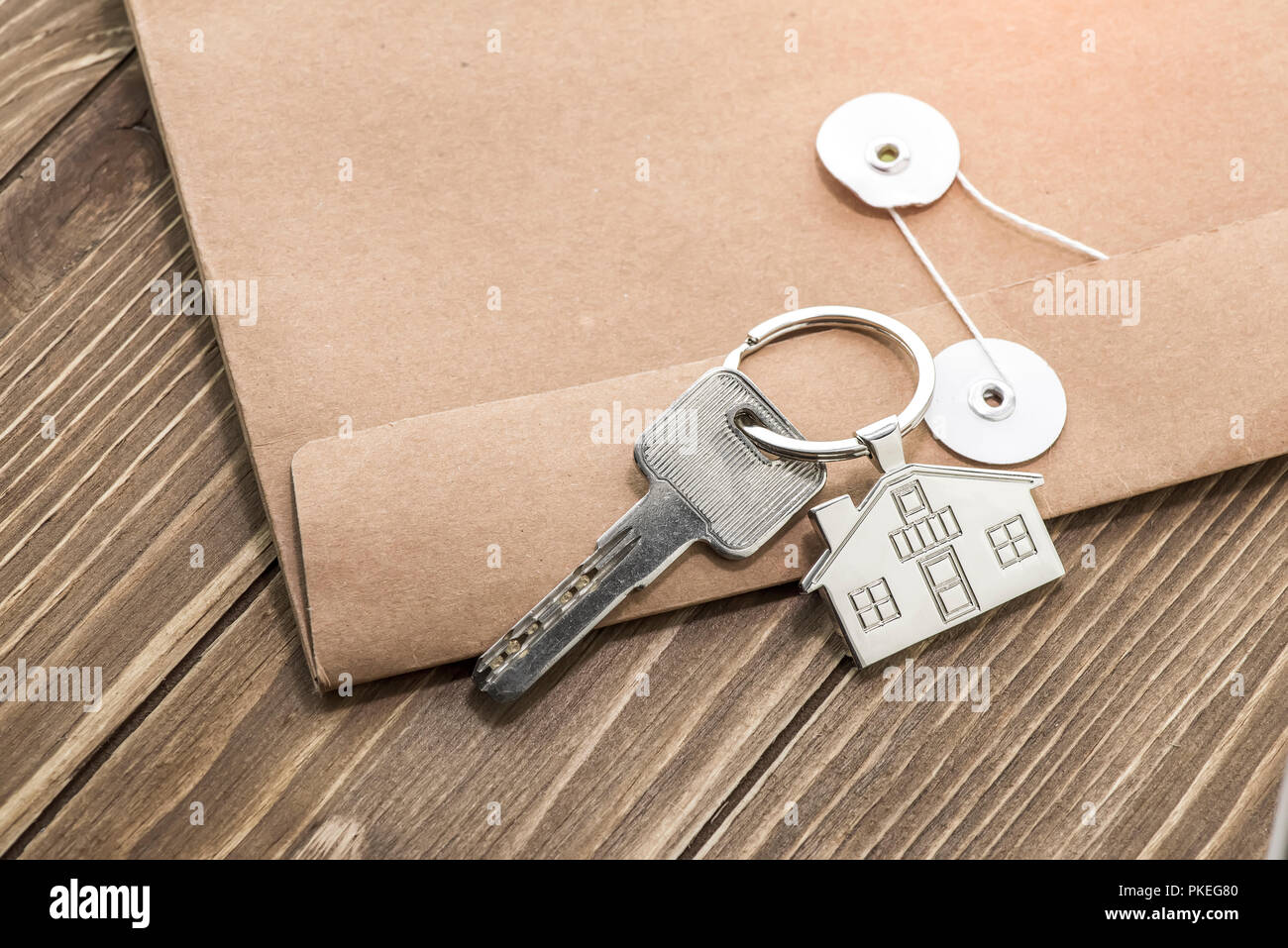 key chain with house symbol and key,Real estate concept Stock Photo - Alamy