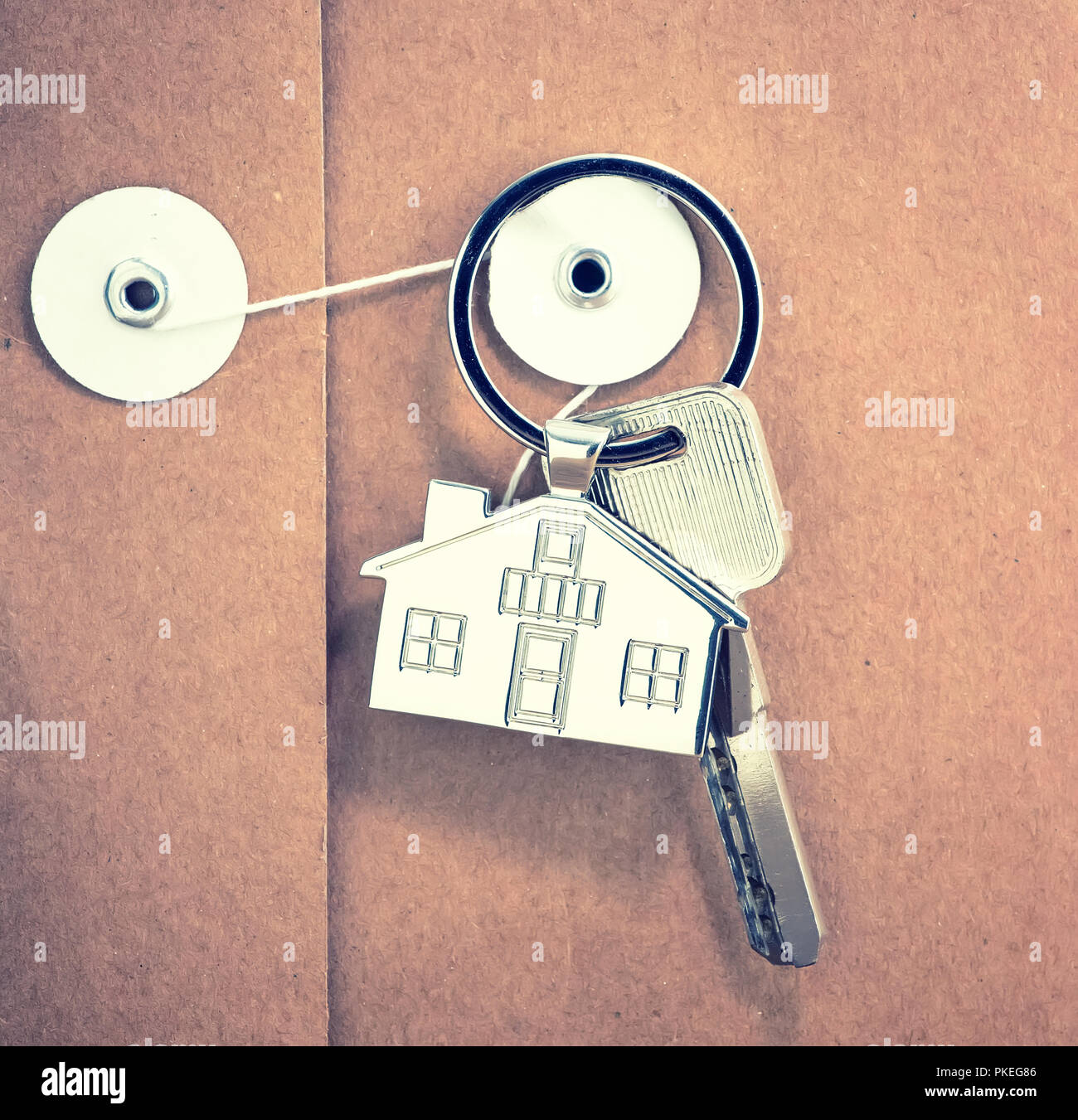 key chain with house symbol and key,Real estate concept Stock Photo - Alamy