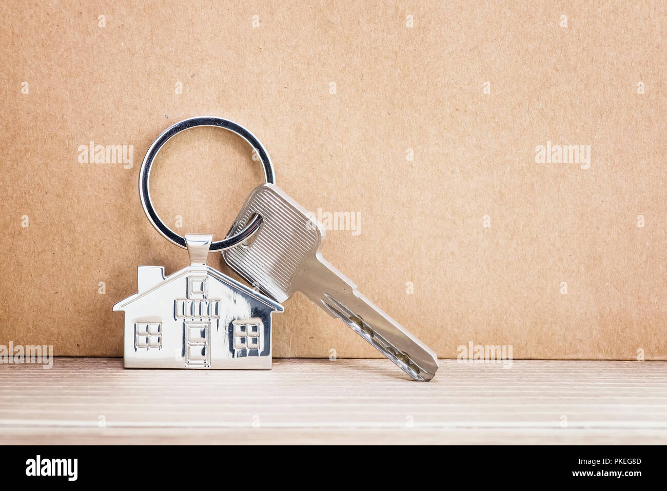 key chain with house symbol and key,Real estate concept Stock Photo - Alamy