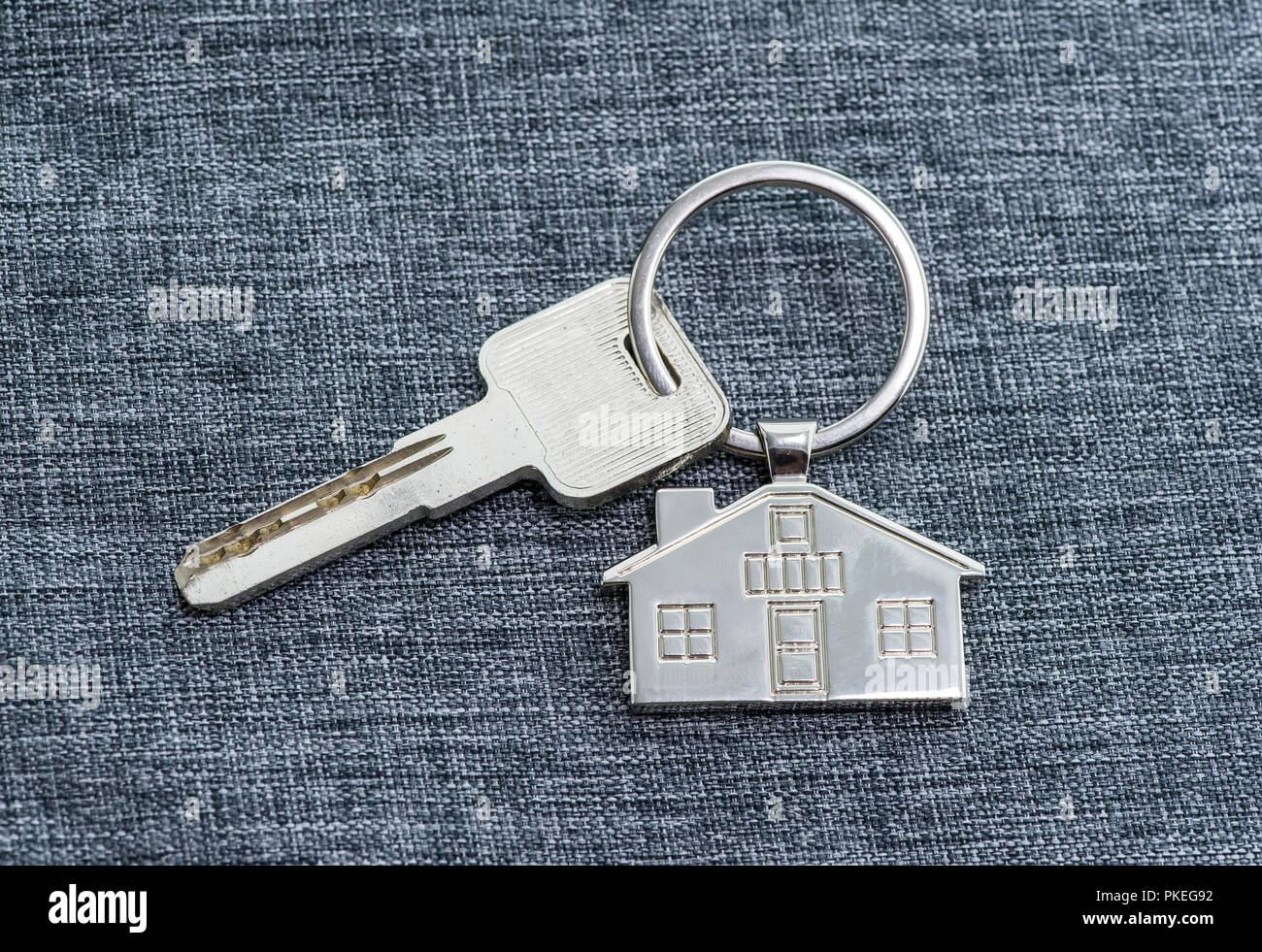 key chain with house symbol and key,Real estate concept Stock Photo - Alamy