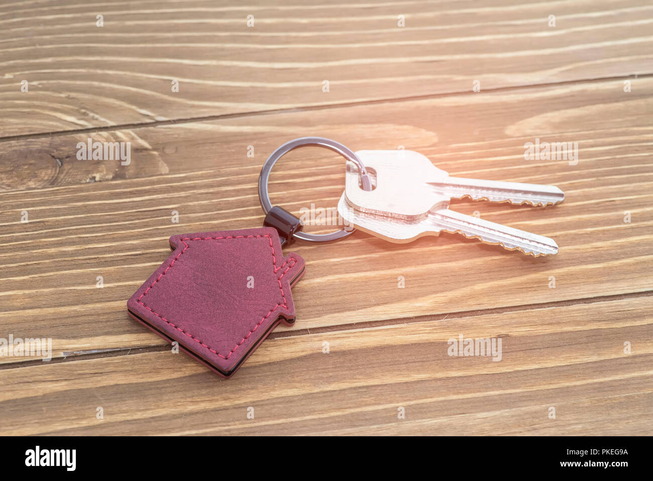 keychain with house symbol and keys on wooden background,Real estate ...