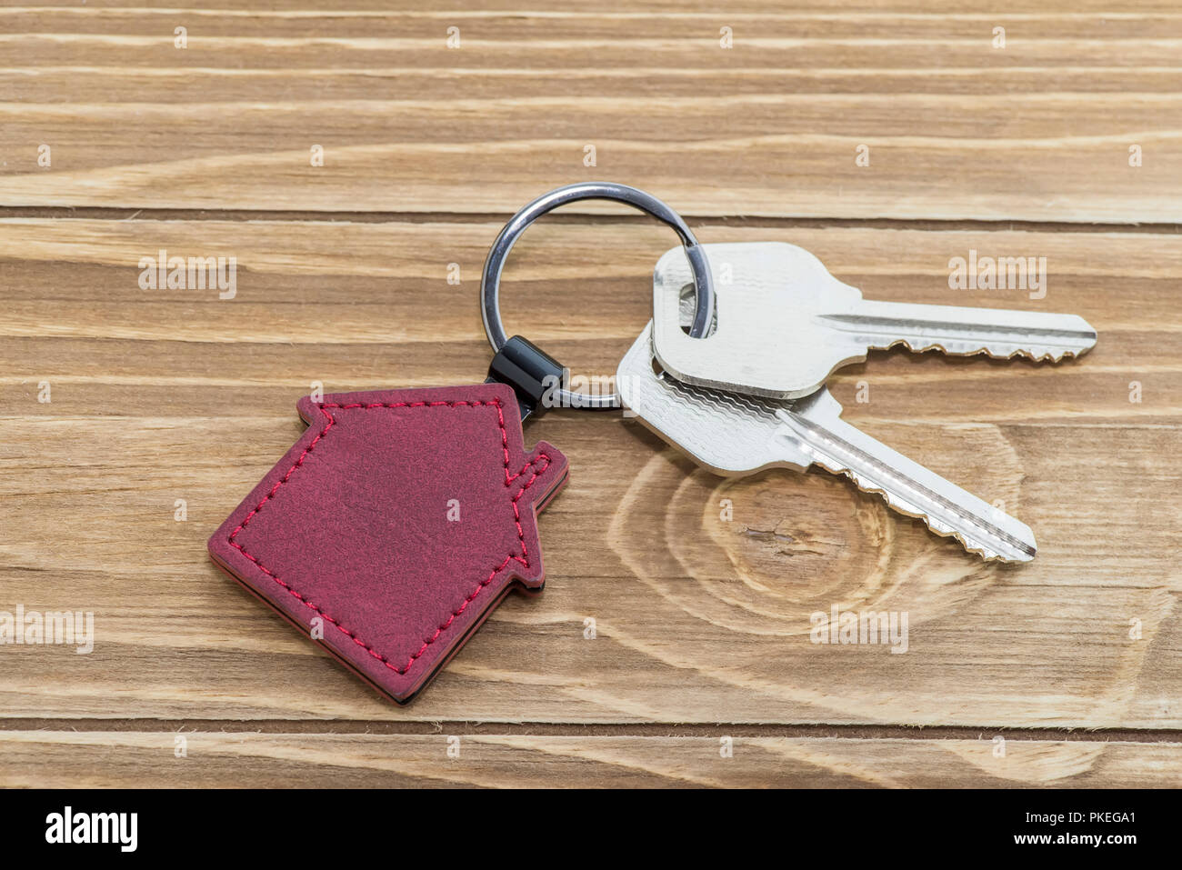 keychain with house symbol and keys on wooden background,Real estate ...