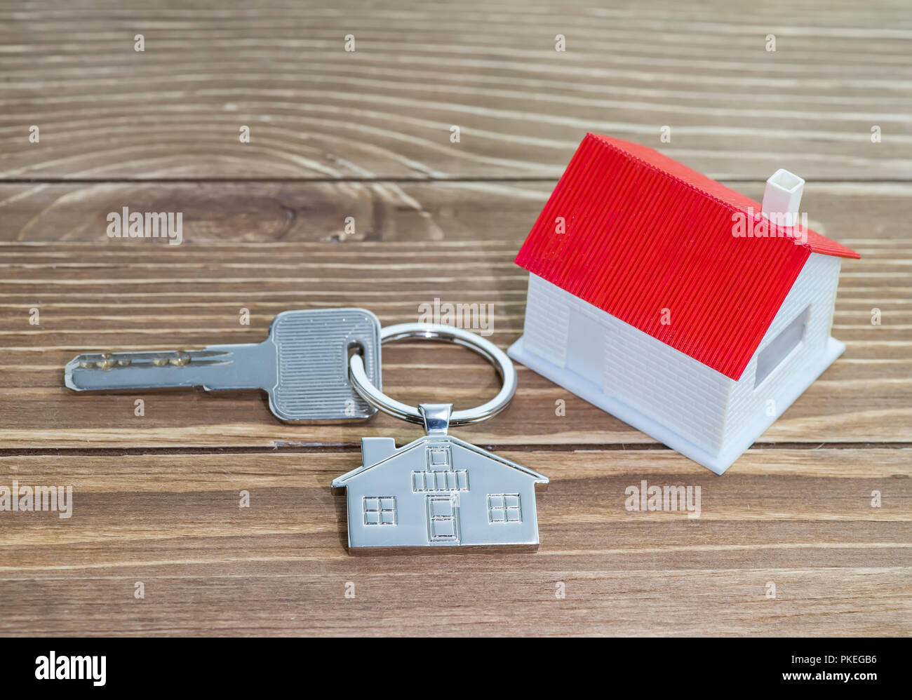 keychain with house symbol and keys on wooden background,Real estate ...
