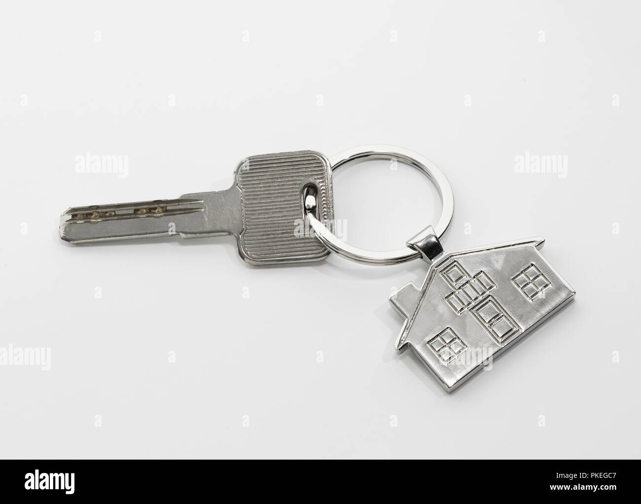 Key and keychain in the shape of a house isolated on white background ...