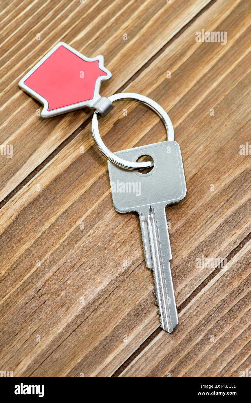 keychain with house symbol and keys on wooden background,Real estate ...