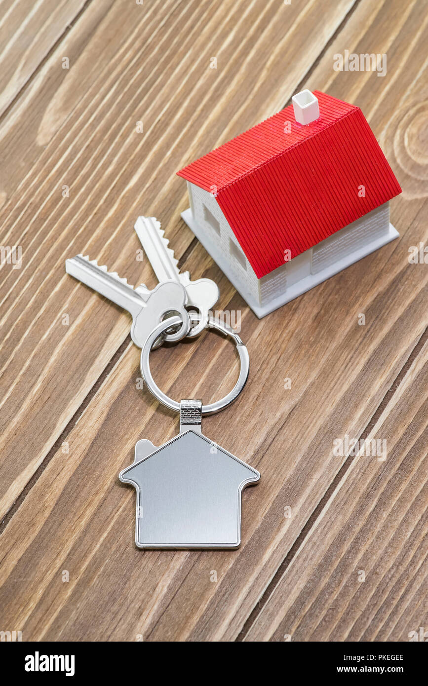 keychain with house symbol and keys on wooden background,Real estate ...