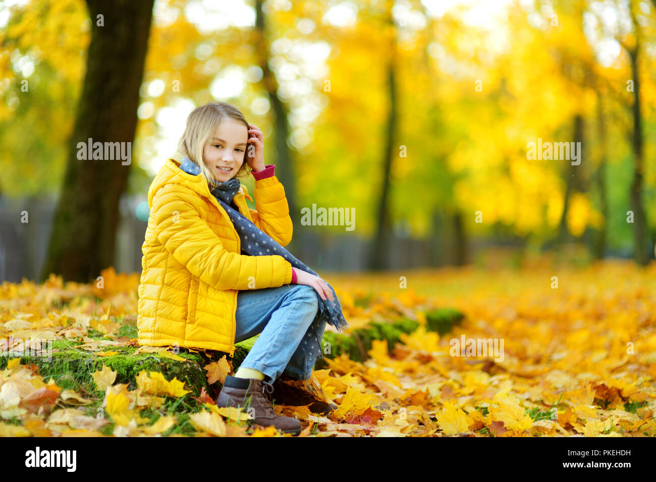 Cute little girl having fun on beautiful autumn day. Happy child ...