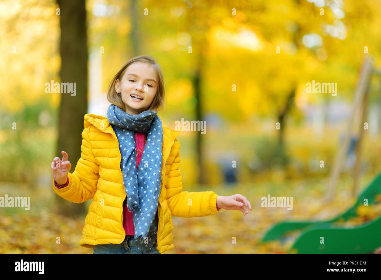 Cute little girl having fun on beautiful autumn day. Happy child ...