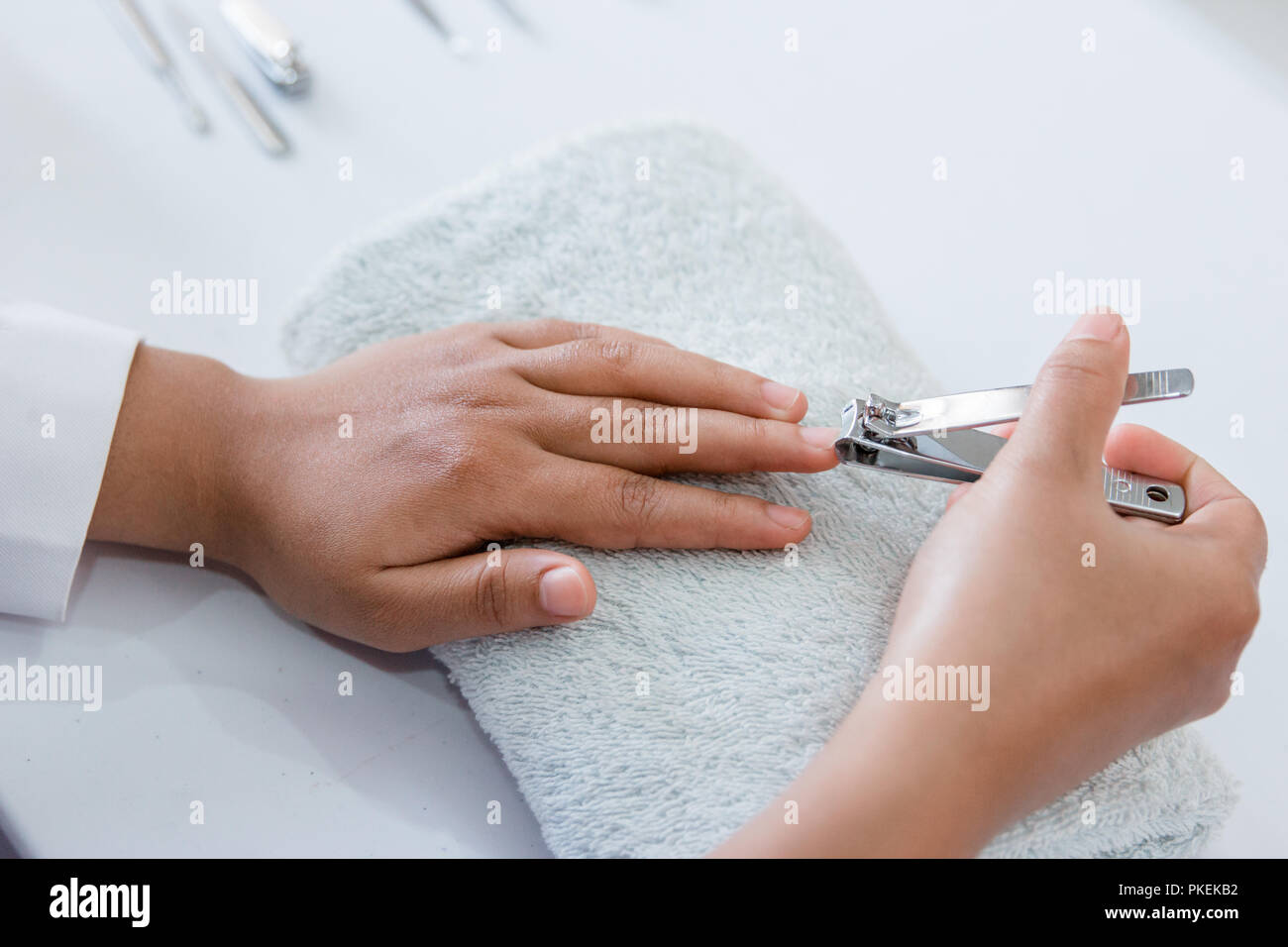 Hand manicure with nail clipper Stock Photo - Alamy