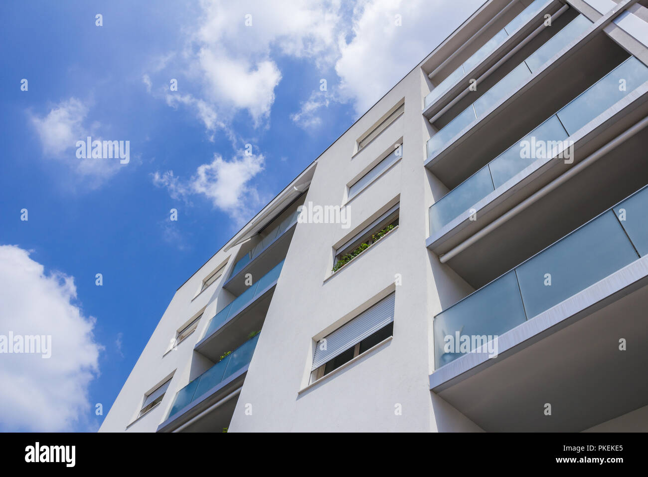 Modern new apartment with concrete exterior walls and large glass ...