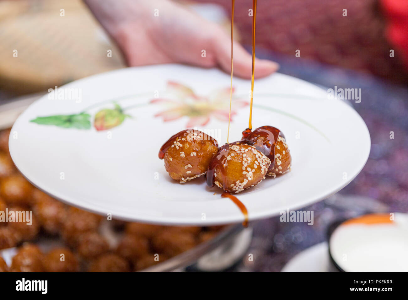 Luqaimat doughnut balls drizzled with date syrup in Dubai, United Arab ...