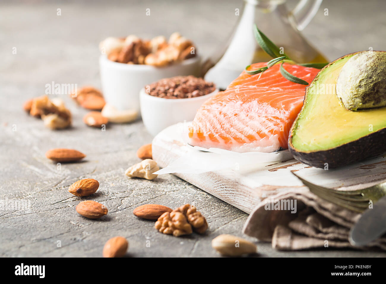Healthy fats in nutrition - salmon, avocado, oil, nuts. Concept of ...