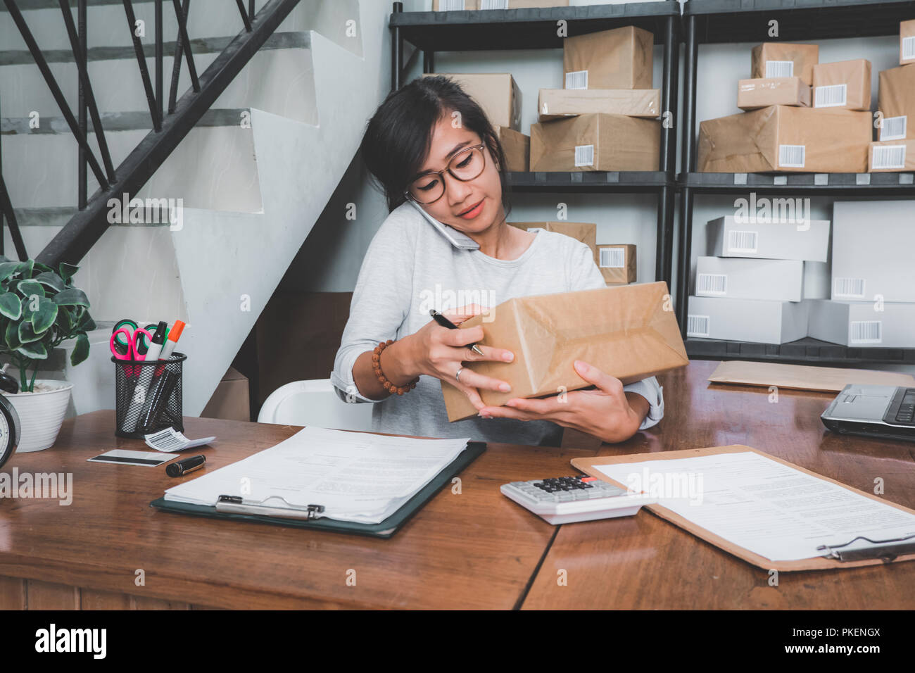 woman counting on package on a shelf Stock Photo - Alamy