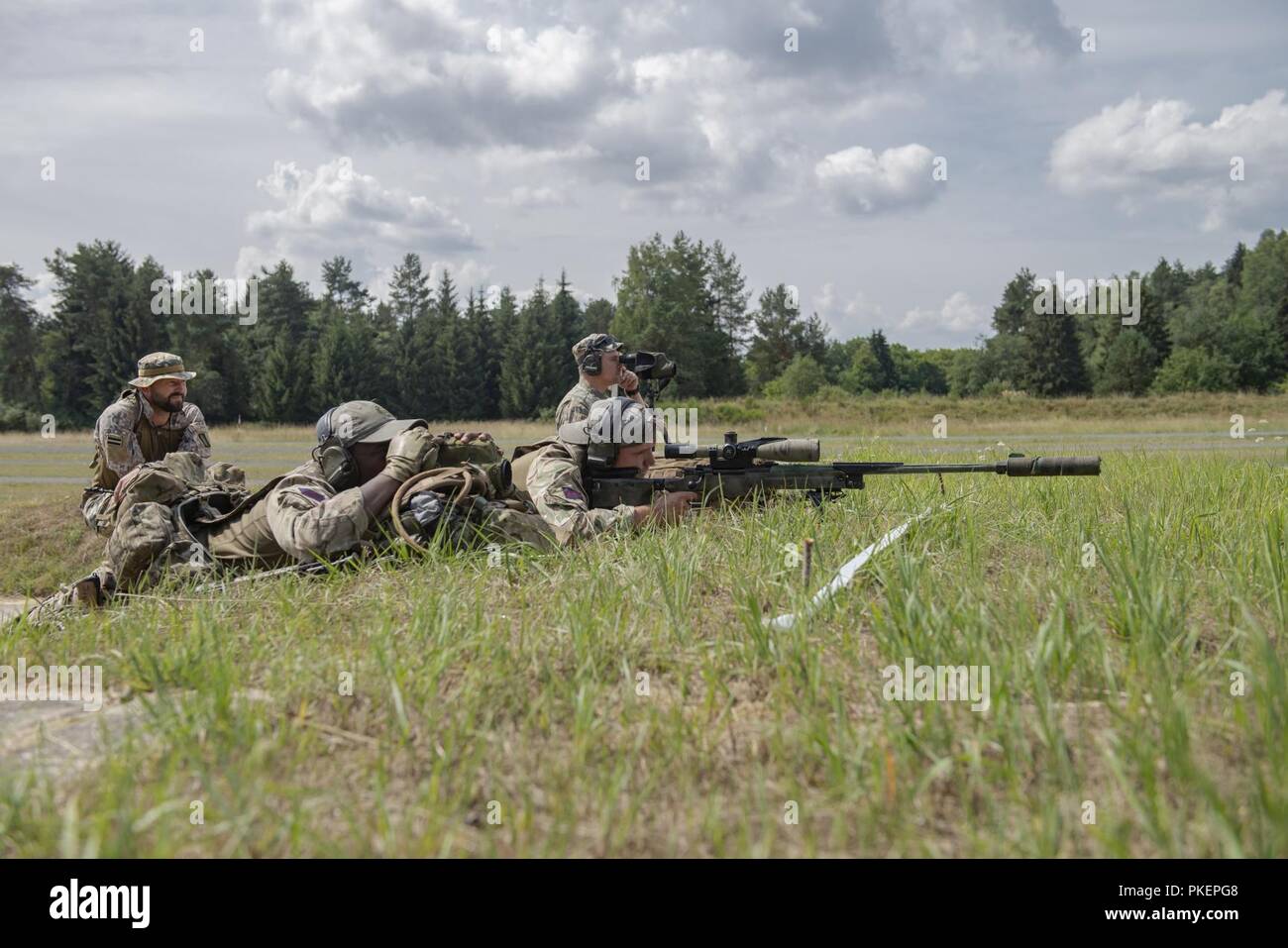 Sniper team from the United Kingdom prepare to fire a long distance ...