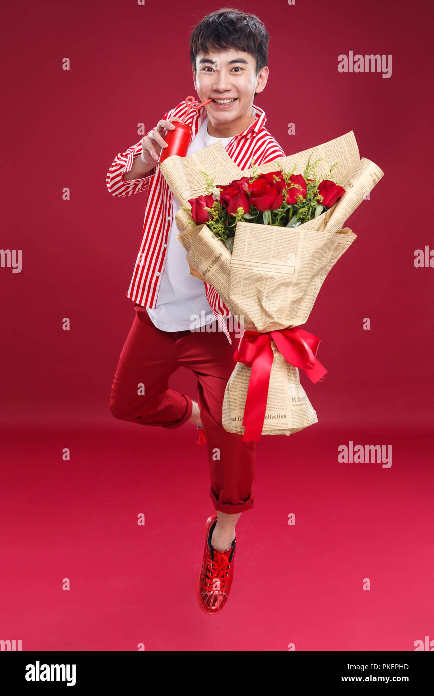 The young man with roses Stock Photo - Alamy