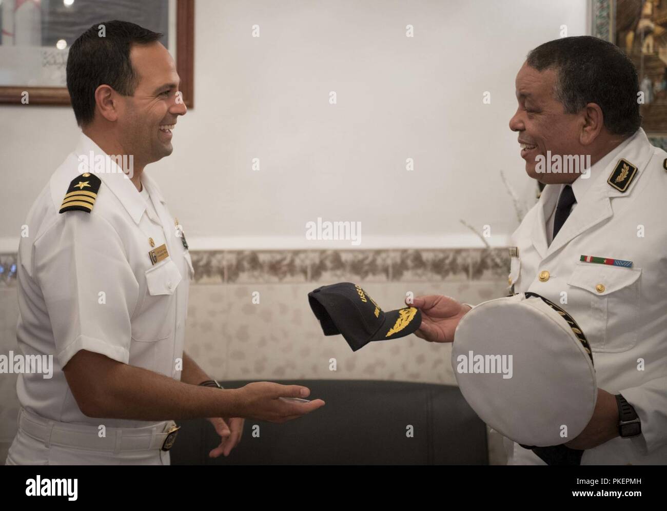 Algeria (July 29, 2018) Cmdr. Tyson Young, left, commanding officer of ...